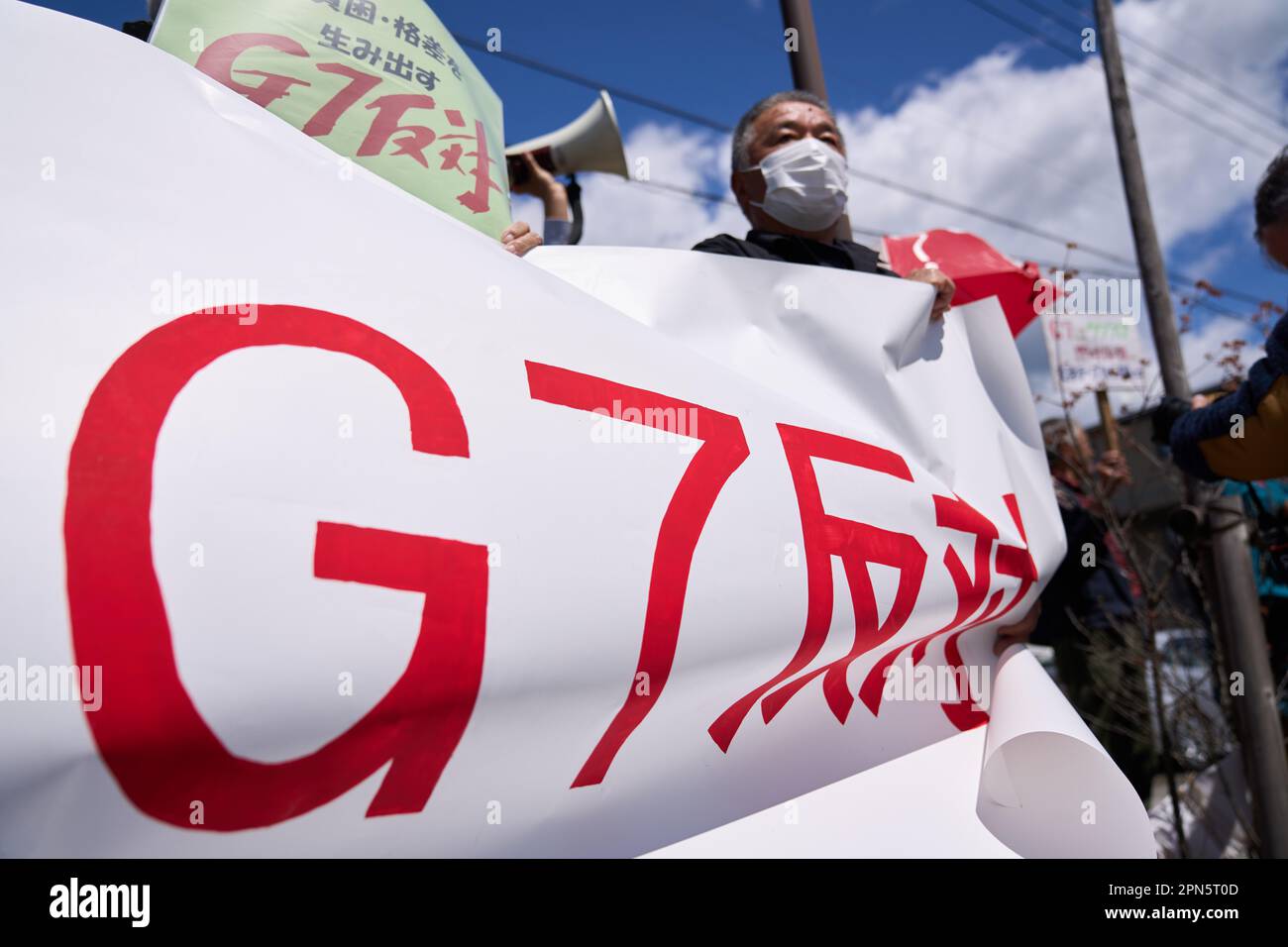 Karuizawa, Japan. 16th Apr, 2023. Protesters holding banners and ...