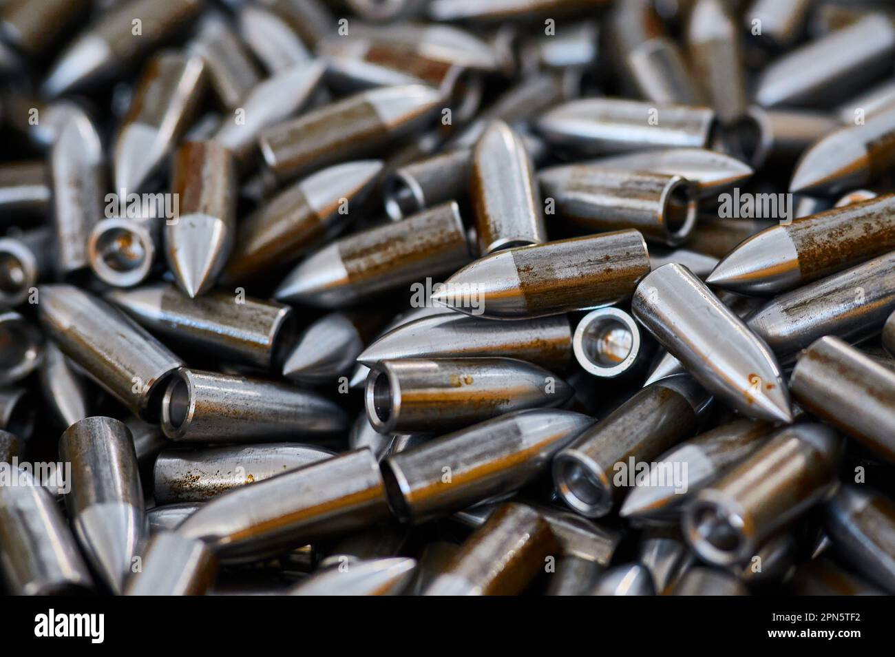 Scattered grey bullets armour ammunition as background Stock Photo - Alamy