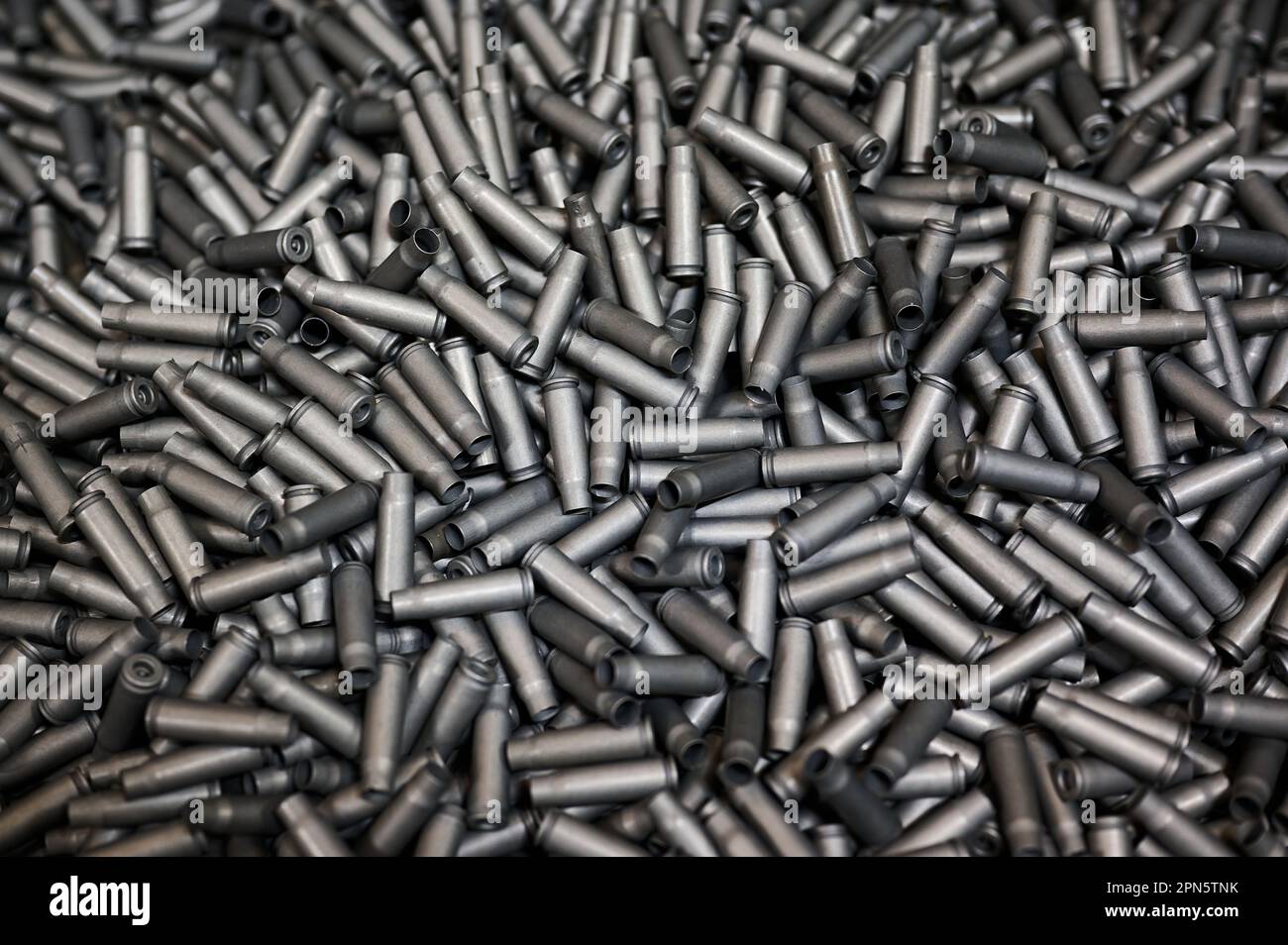 Grey shell casings in container at armor production plant Stock Photo ...