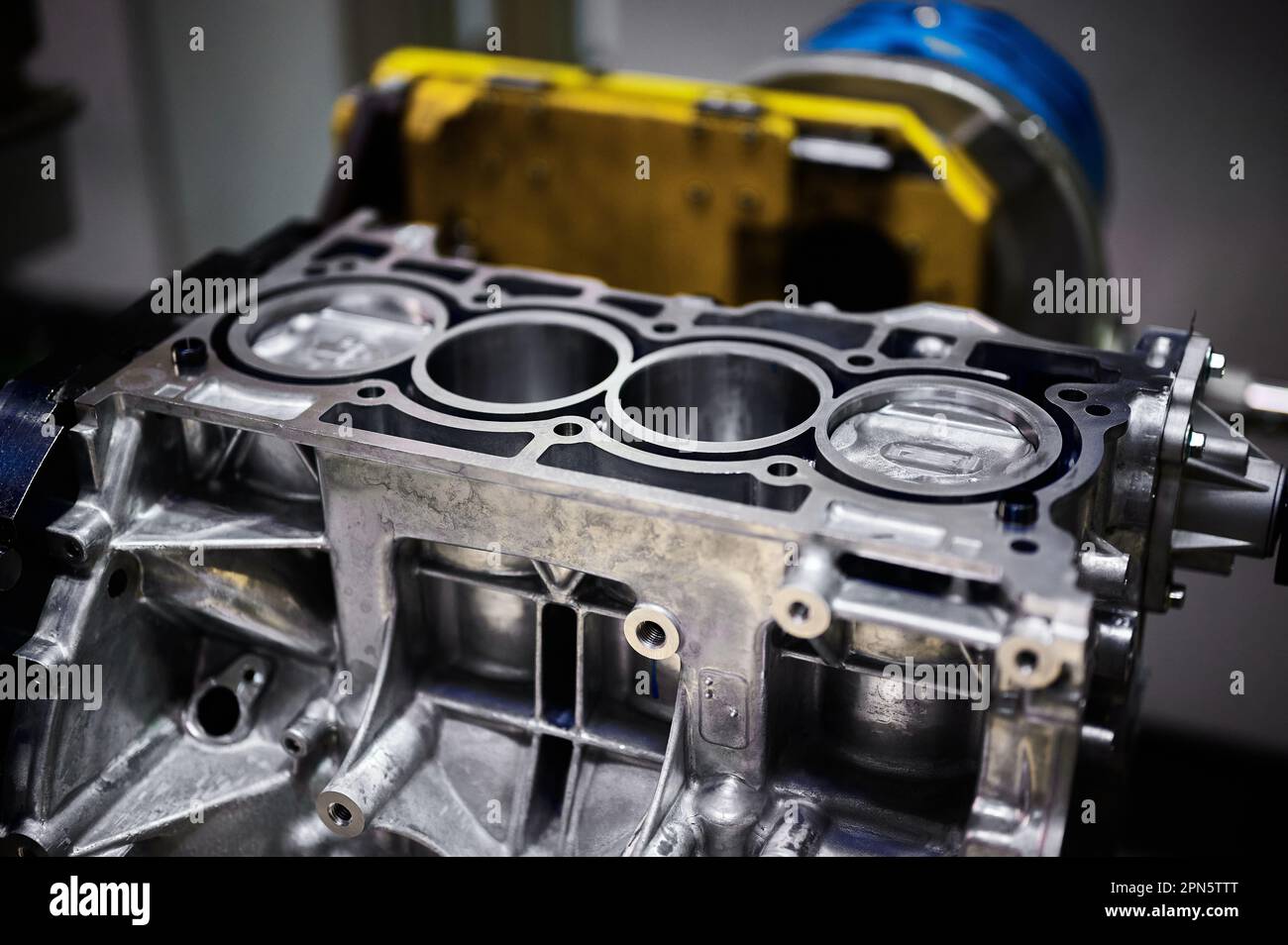 Engine cylinder block with installed pistons in workshop Stock Photo ...