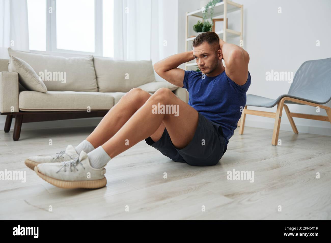 Man sportsman training at home, push-up exercises for arm, leg and back ...
