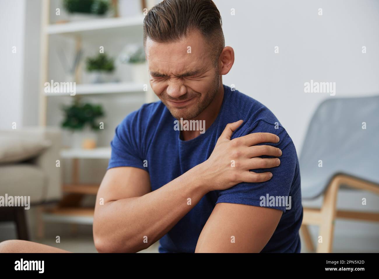 Man athlete pain and injury back arm and leg at home, sports injury ...