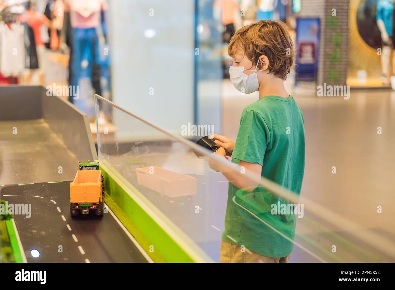 Adorable cute little child playing with toy on remote control, in the ...