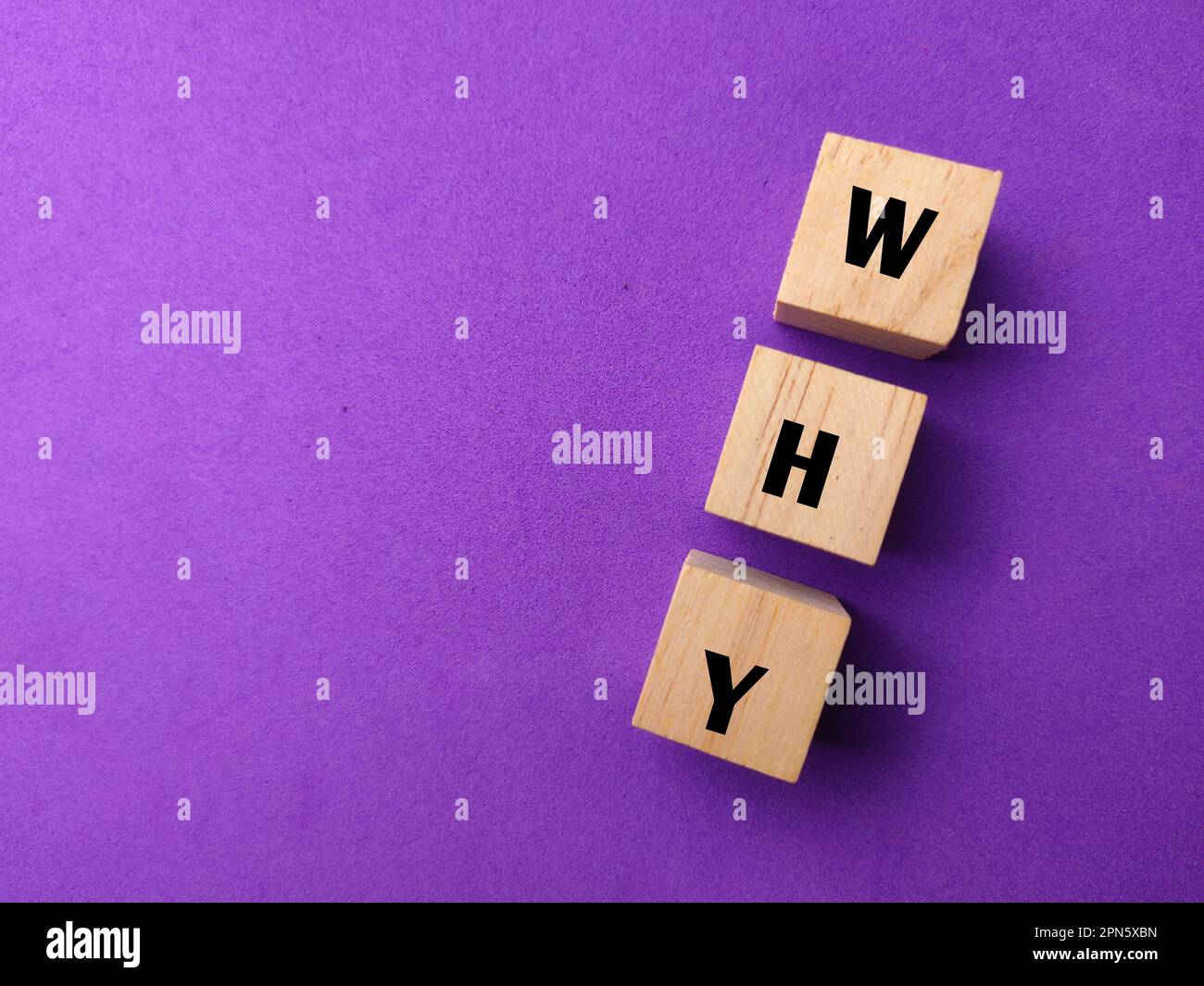 Wooden block with the word WHY on a purple background Stock Photo - Alamy