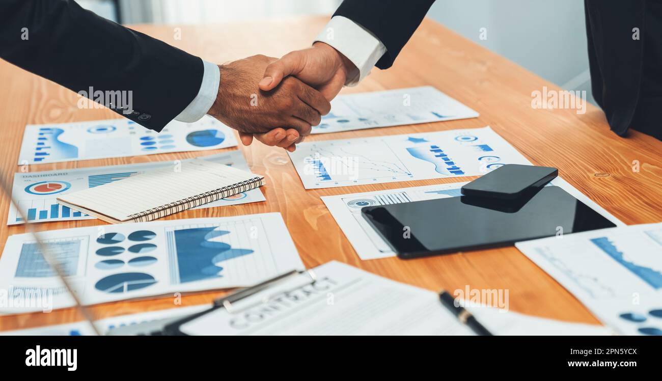 Closeup professional businessman shaking hands over desk in modern ...