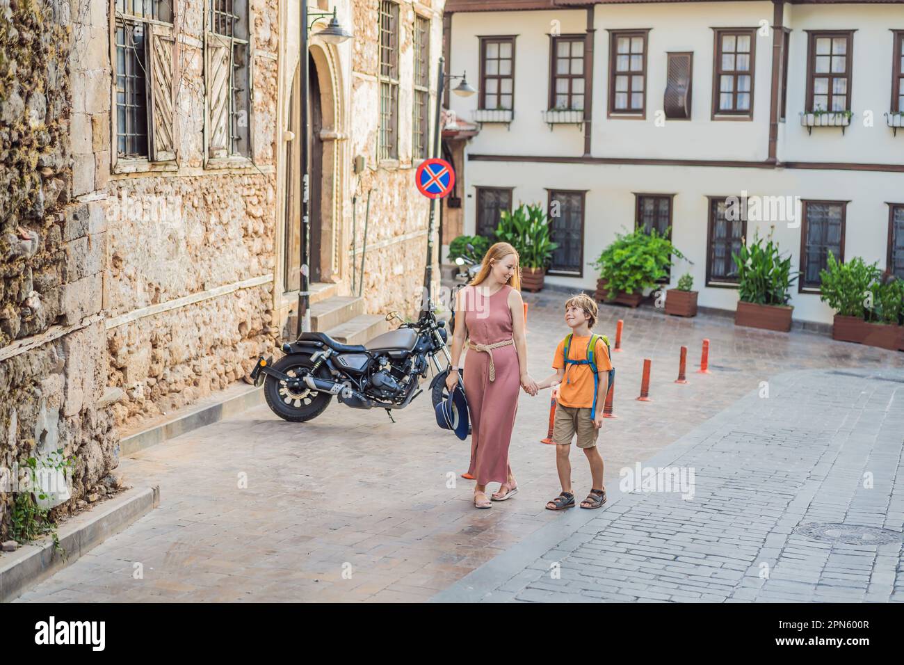 Mom and son tourists in Old town Kaleici in Antalya. Turkiye. Panoramic ...