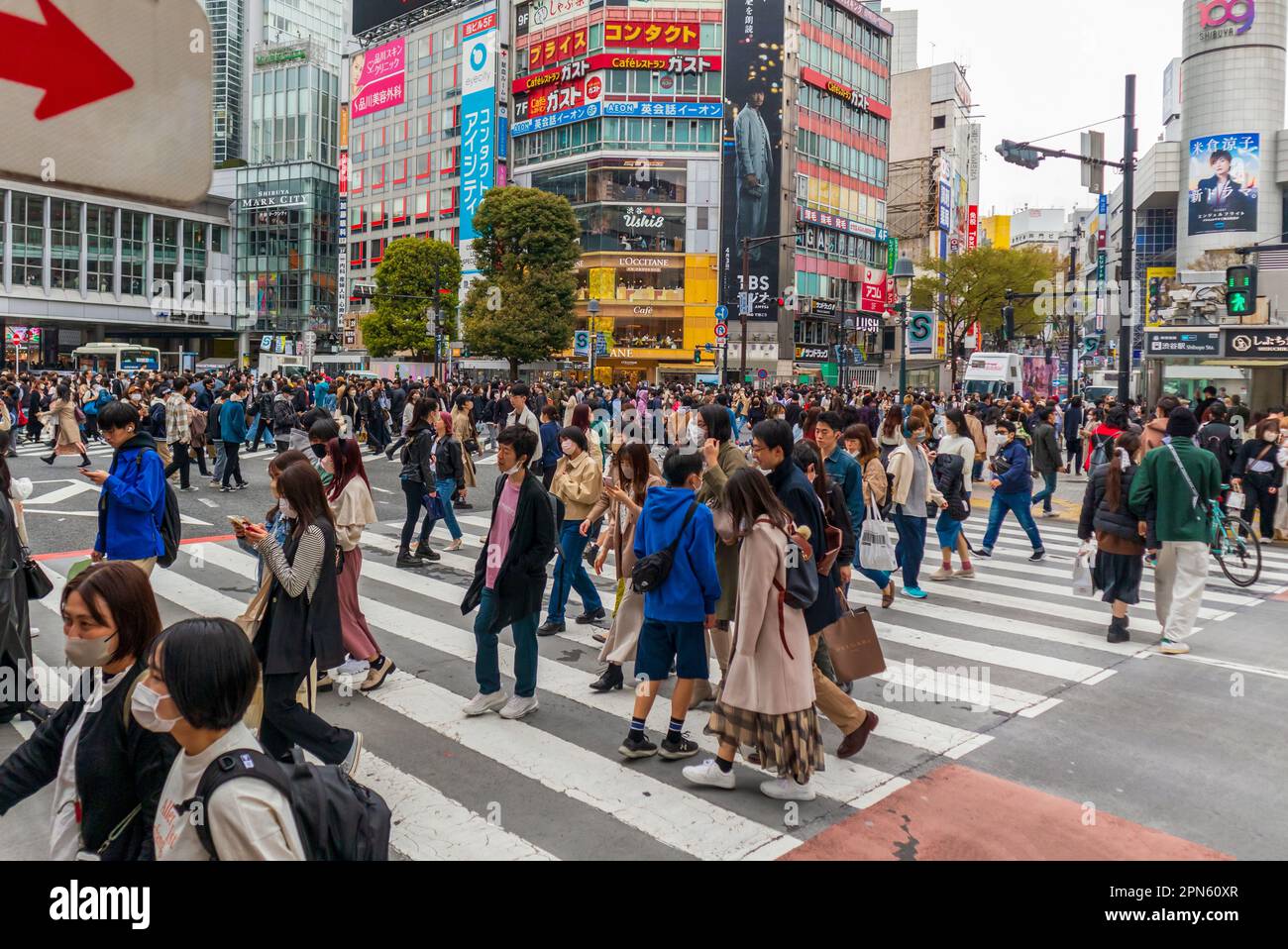 Tokyo, Japan - March 21, 2023: People walking along the busy streets and crossing at the famous ...