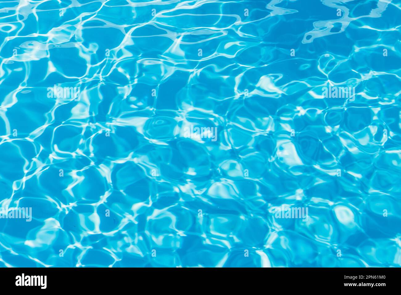 Blue pool water with sun reflections background Stock Photo - Alamy