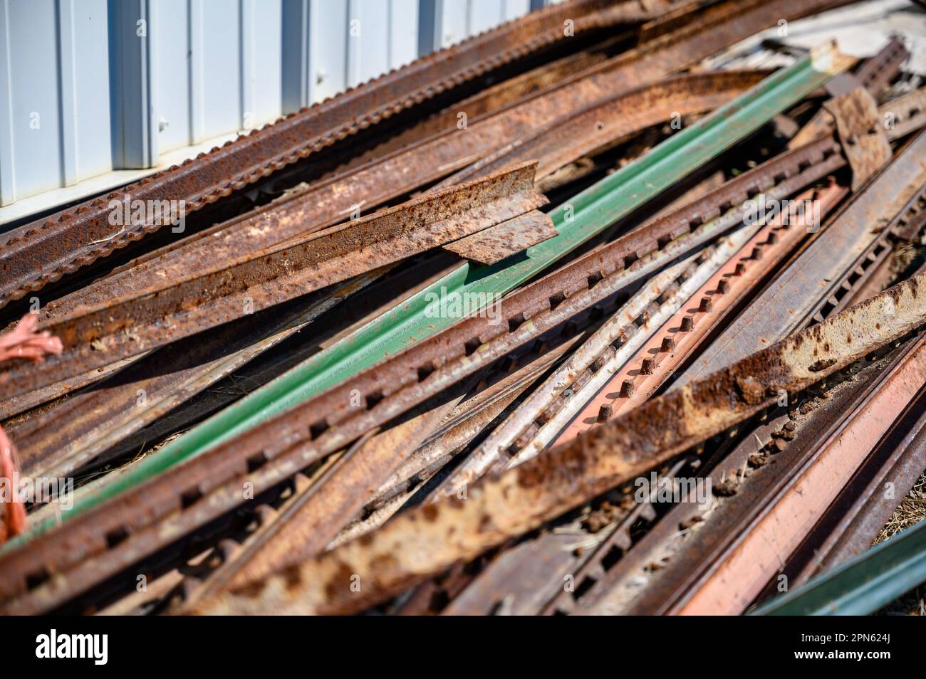 Pile of rusted steel fence posts on the ground Stock Photo - Alamy