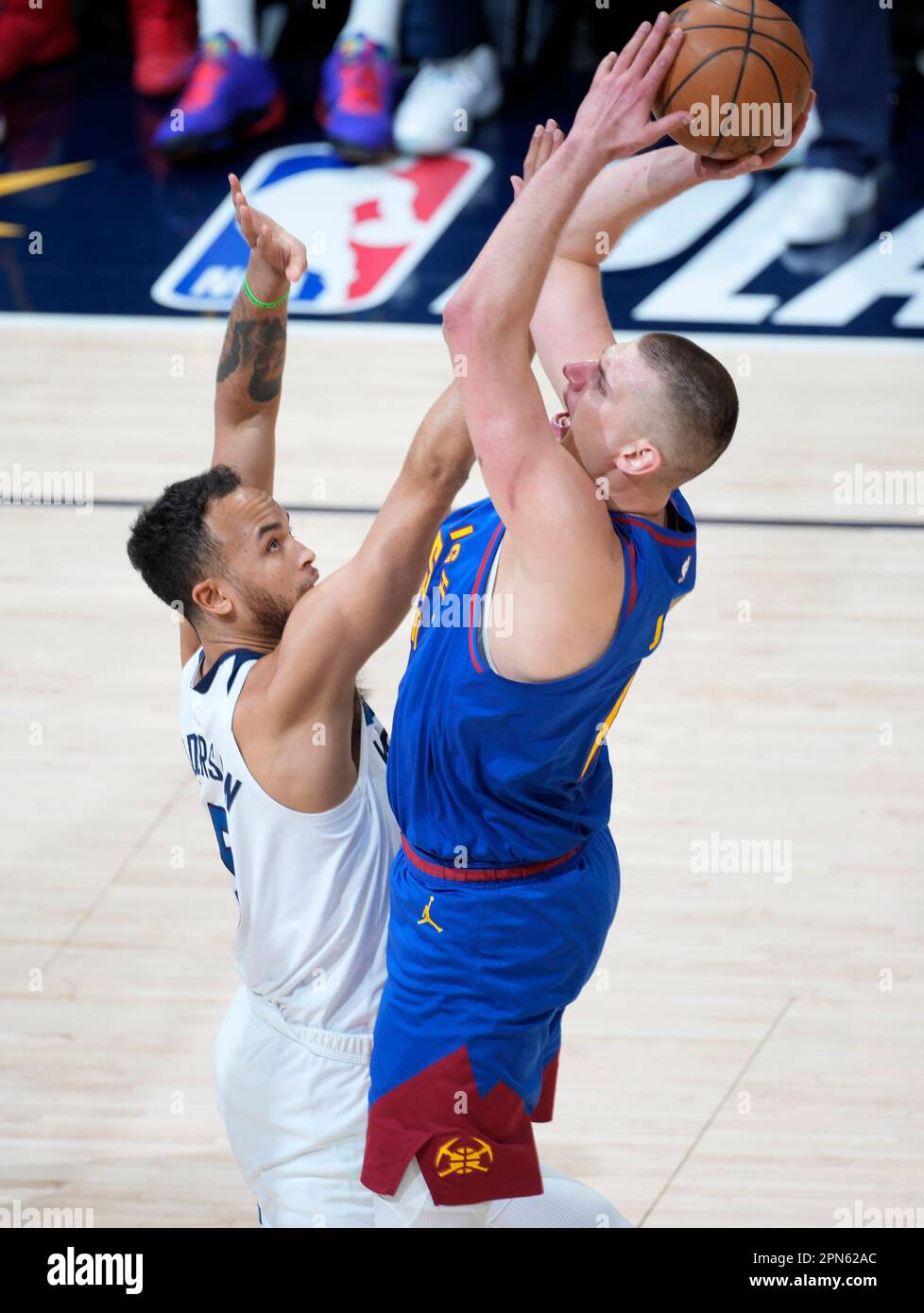 Denver Nuggets center Nikola Jokic, right, goes up for a shot over ...