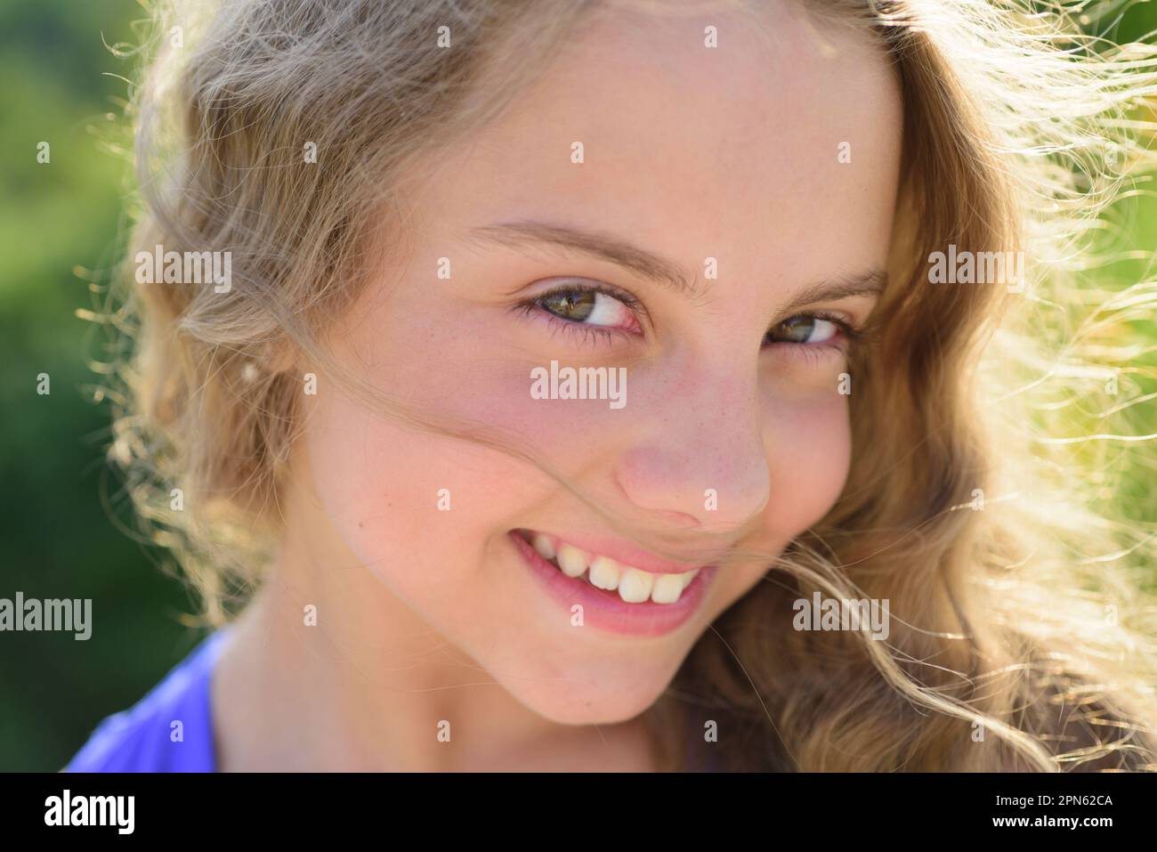 Cute little smiling happy girl close up face. Portrait of kid outdoors ...