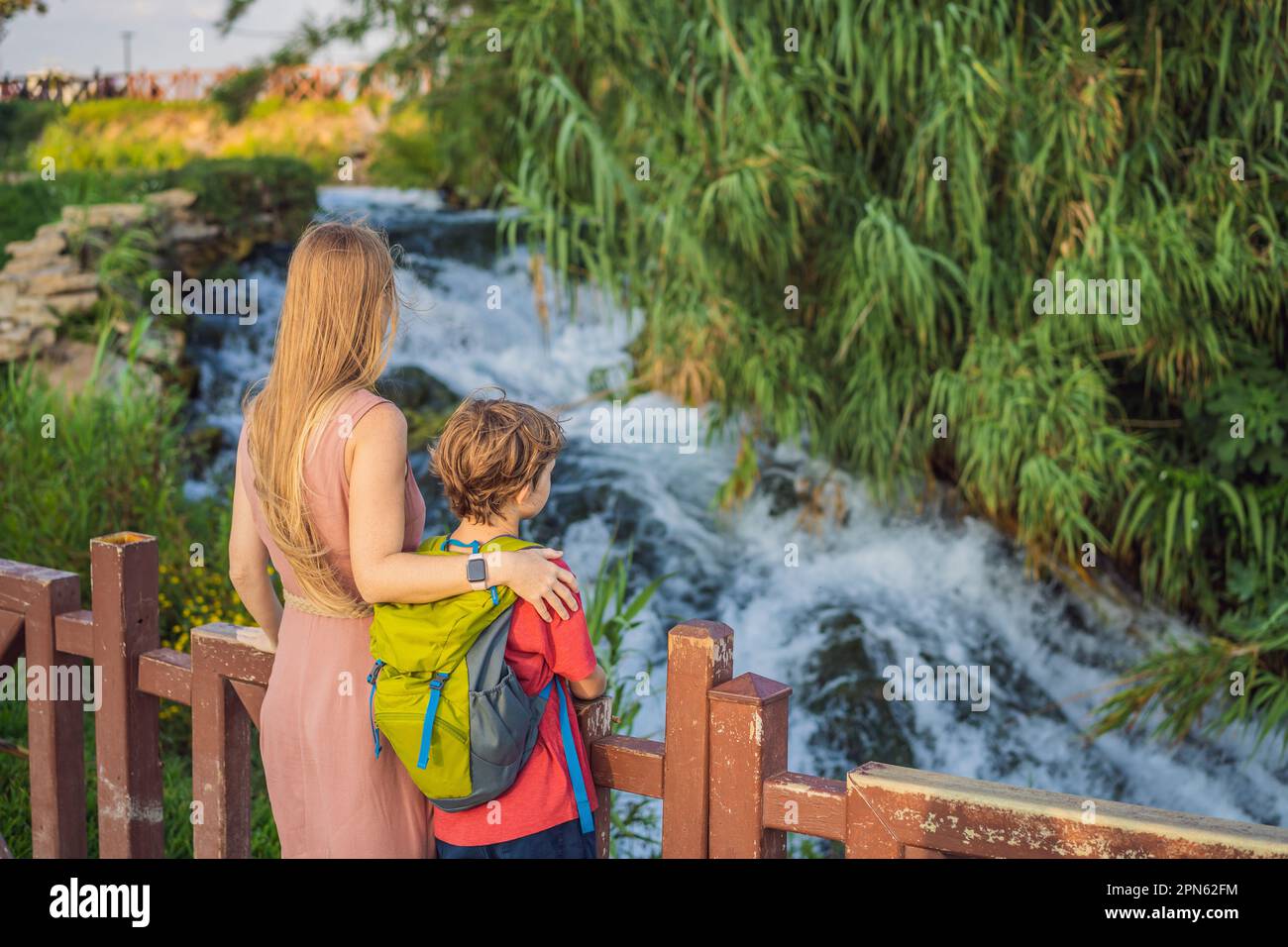 Mother and son tourists on the background of Duden waterfall in Antalya ...
