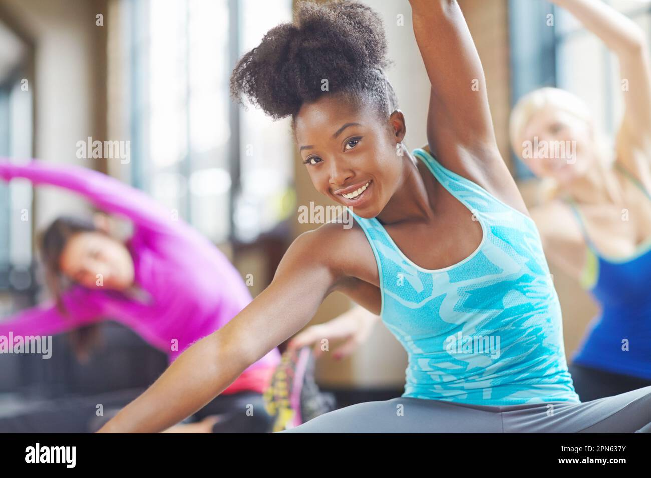 Her happy pose. an attractive woman stretching in yoga class Stock ...