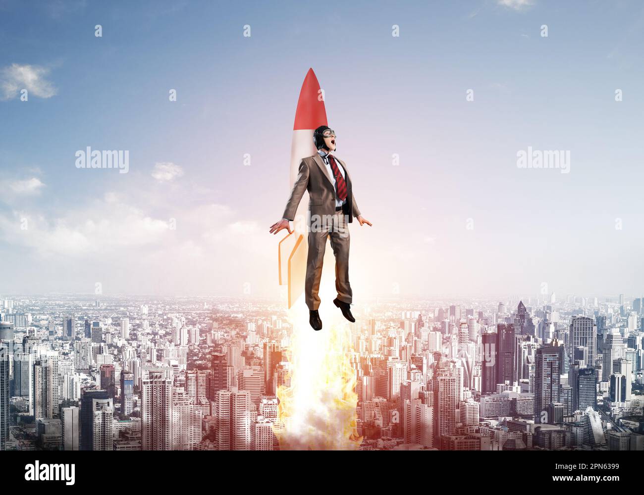 Business person in aviator hat flying on rocket Stock Photo - Alamy