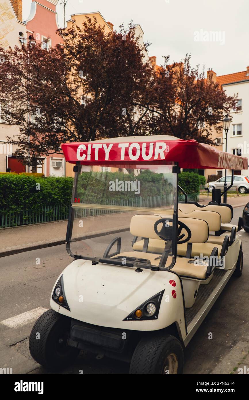 Red City tour car in the old city with text sign of Sightseeing city ...