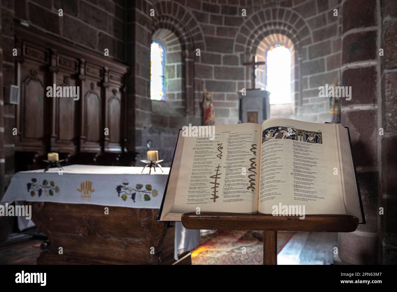A mass book or an open bible in a church in front of a religious altar ...