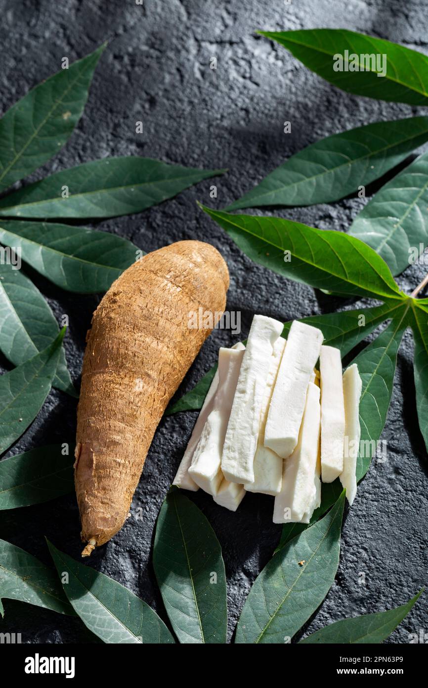 pile of cassava fruit and cassava flour on a background of rustic and ...