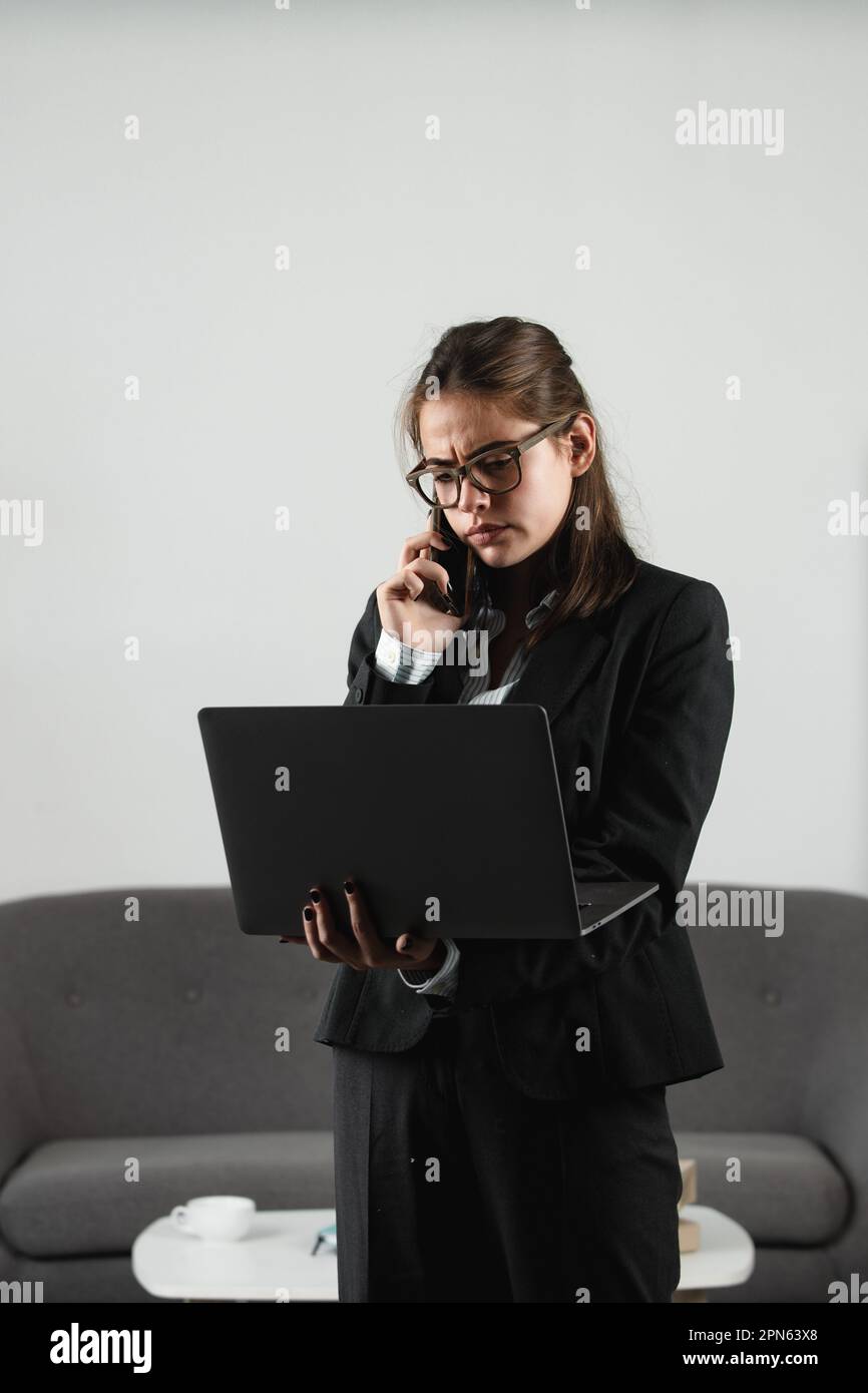 Serious secretary taking a call. Business woman entrepreneur working in ...