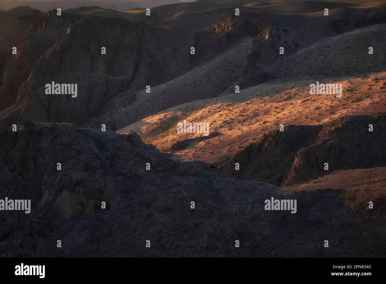 Sand dune among black rocks in the desert mountains Stock Photo - Alamy