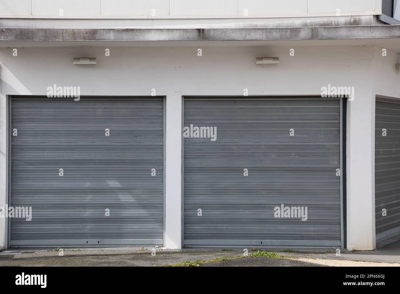 Rolling shutters closed on the facade of a bankrupt store double ...