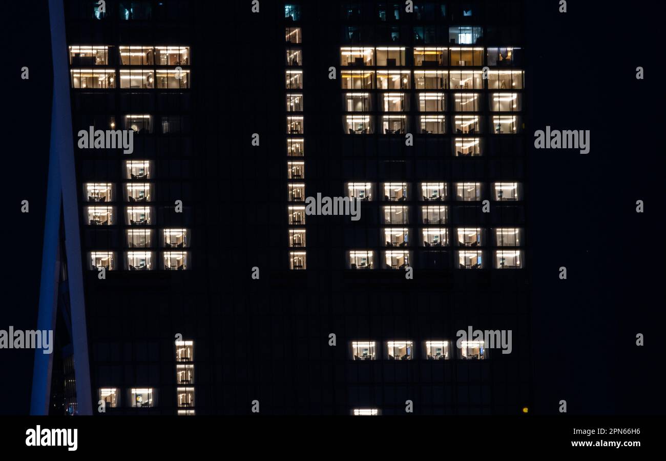 Illuminated windows in high-rise buildings in downtown Singapore Stock ...
