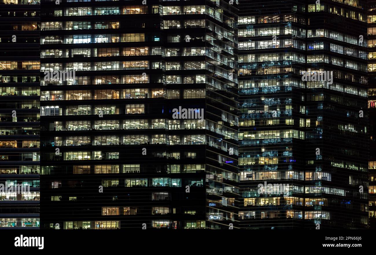Illuminated windows in high-rise buildings in downtown Singapore Stock ...