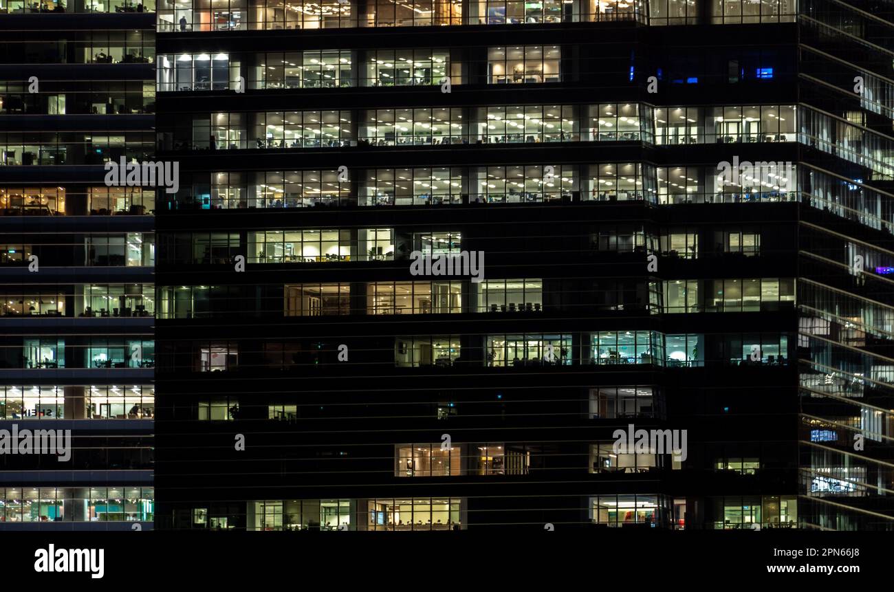 Illuminated windows in high-rise buildings in downtown Singapore Stock ...