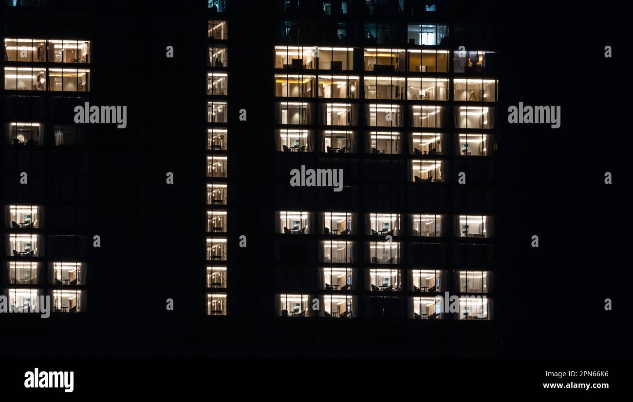 Illuminated windows in high-rise buildings in downtown Singapore Stock ...