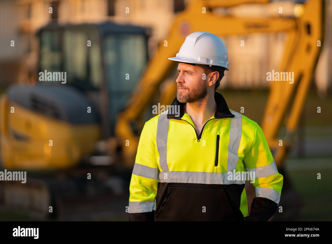 Worker in helmet on site construction. Excavator bulldozer male worker ...