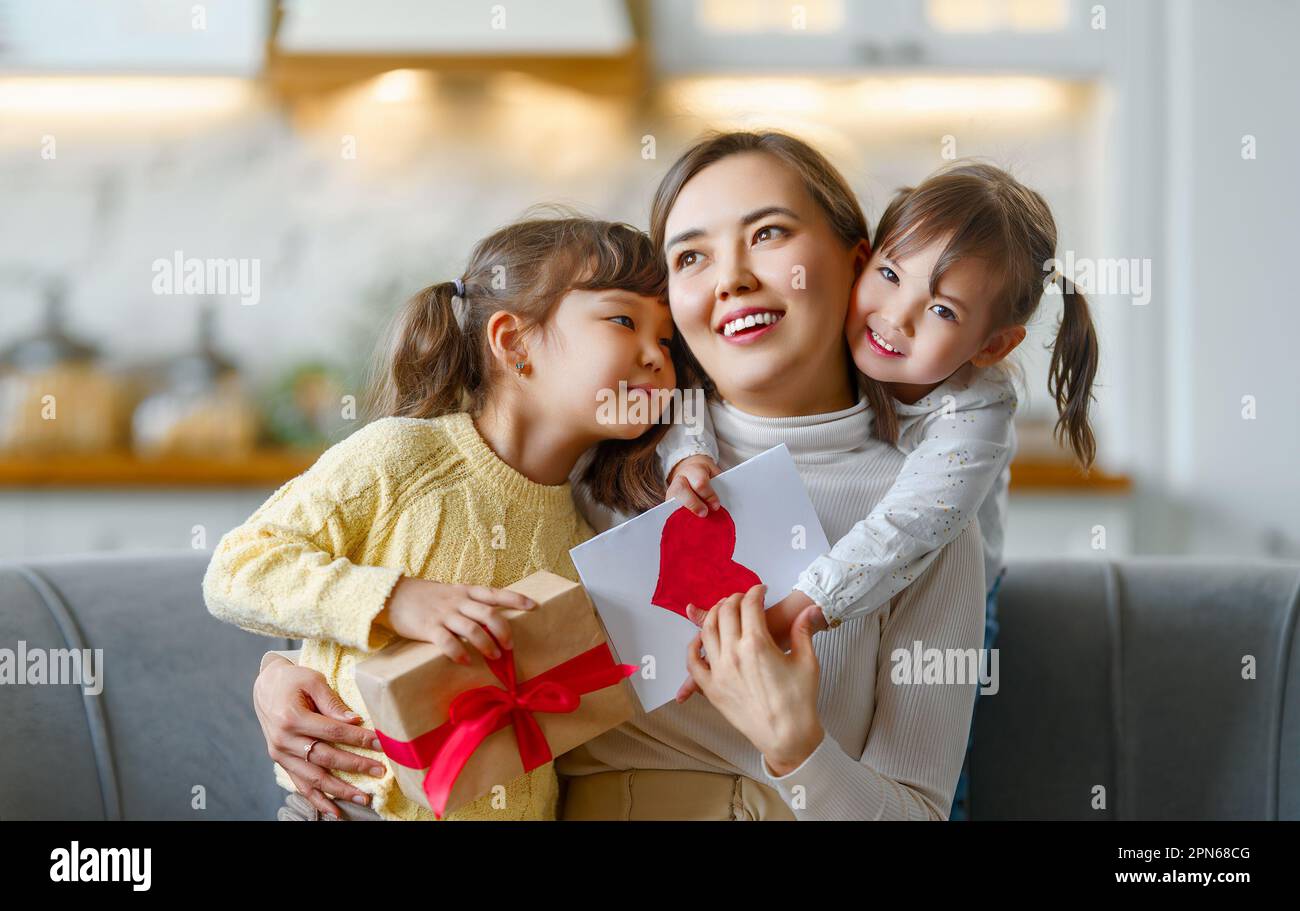 Happy mother's day. Children daughters congratulating their mother and ...