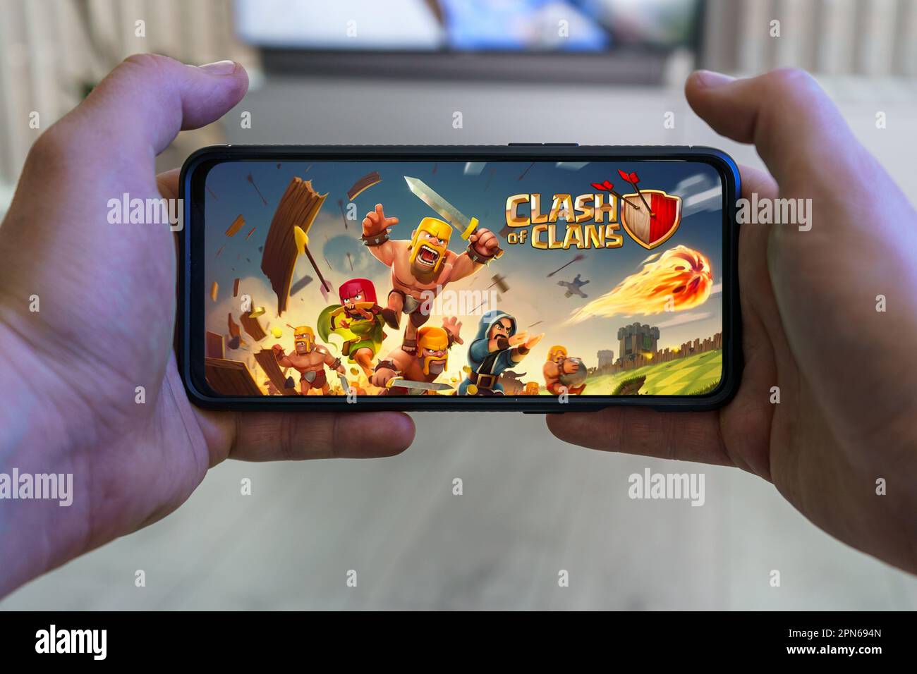 Playing Clash of clans mobile game. Point of view gaming on smartphone ...