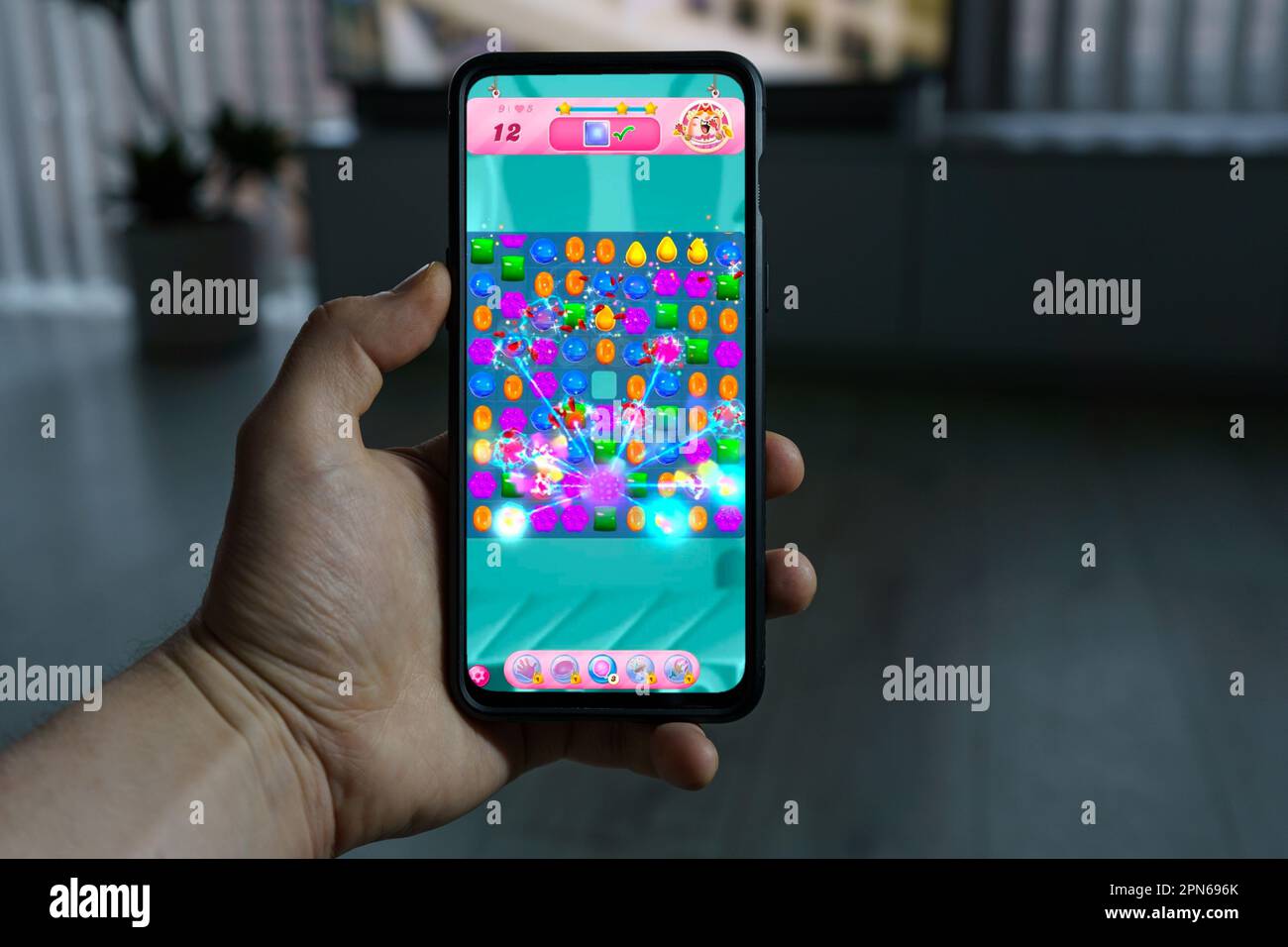 Playing candy crush saga mobile game. Point of view gaming on ...