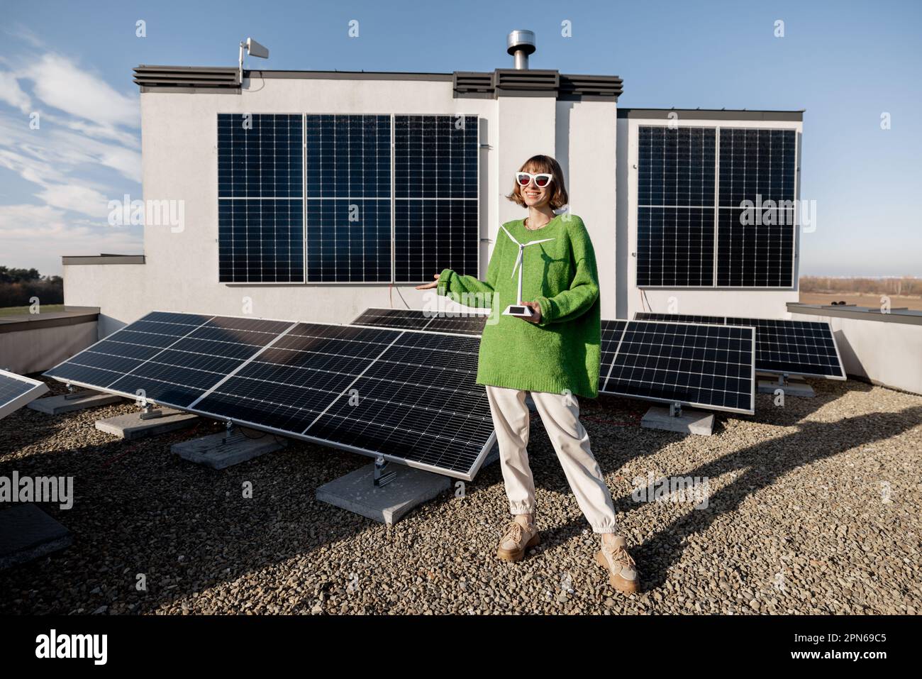 Happy house owner with a solar plant Stock Photo - Alamy