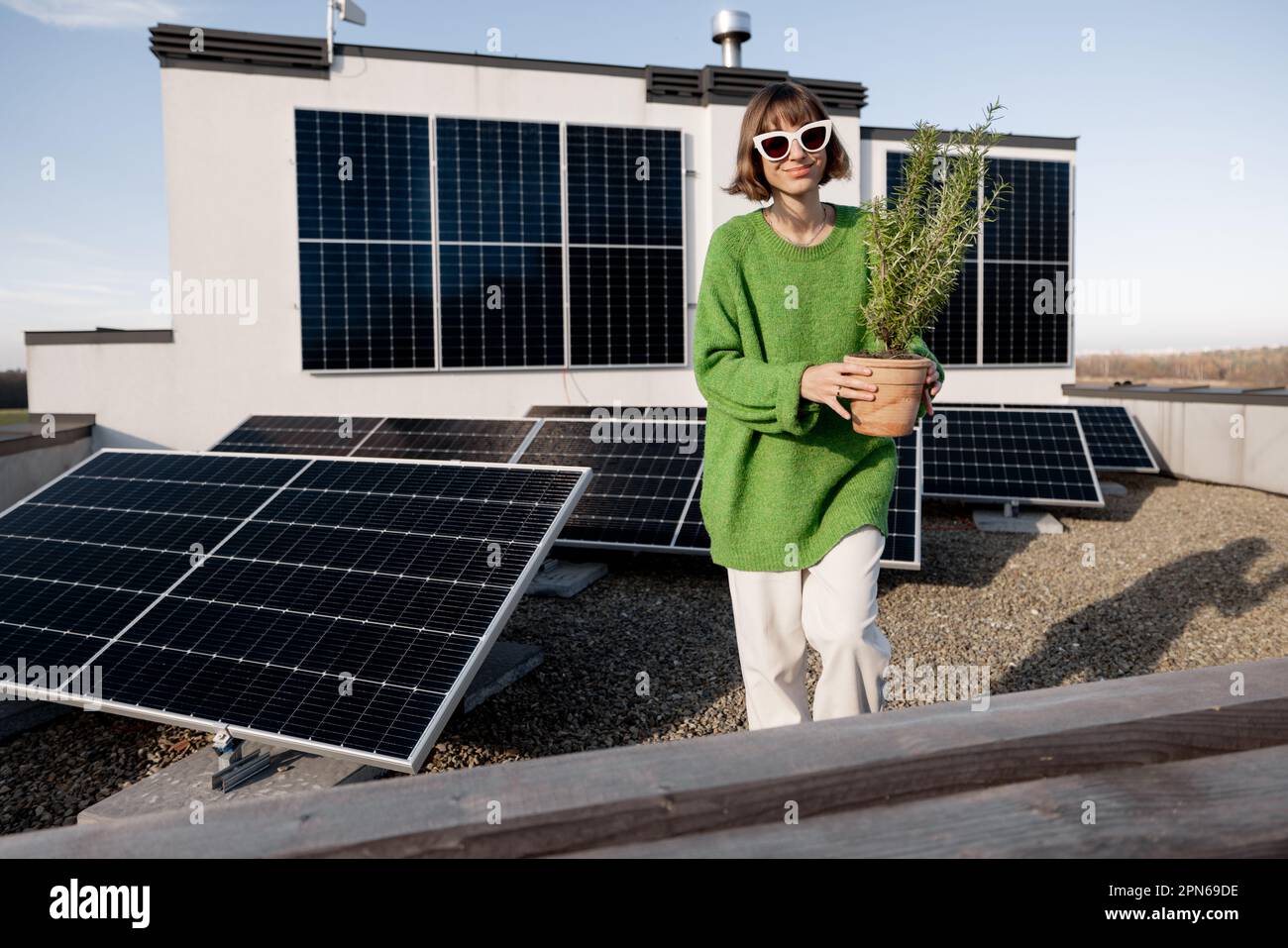 Happy house owner with a solar plant Stock Photo - Alamy