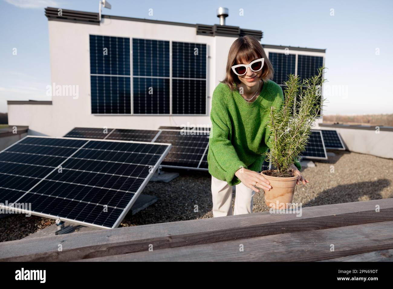 Happy house owner with a solar plant Stock Photo - Alamy