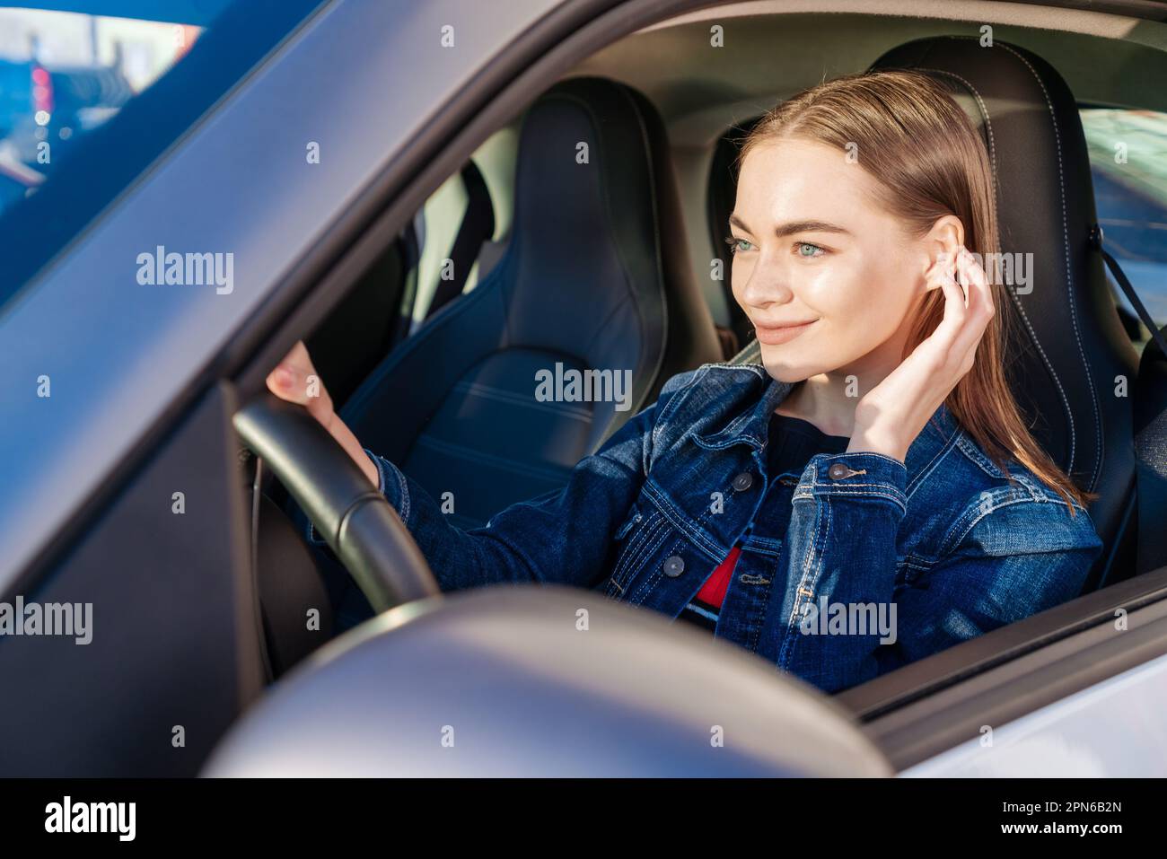 Beautiful young lady happy car. Cute girl who drives car and smiles ...