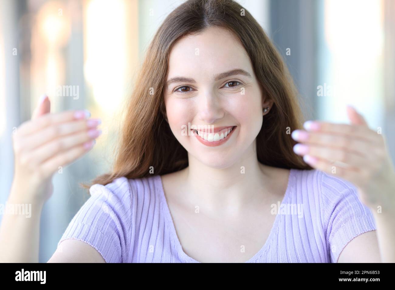 Front view portrait of a happy woman smiling gesturing come here in the ...