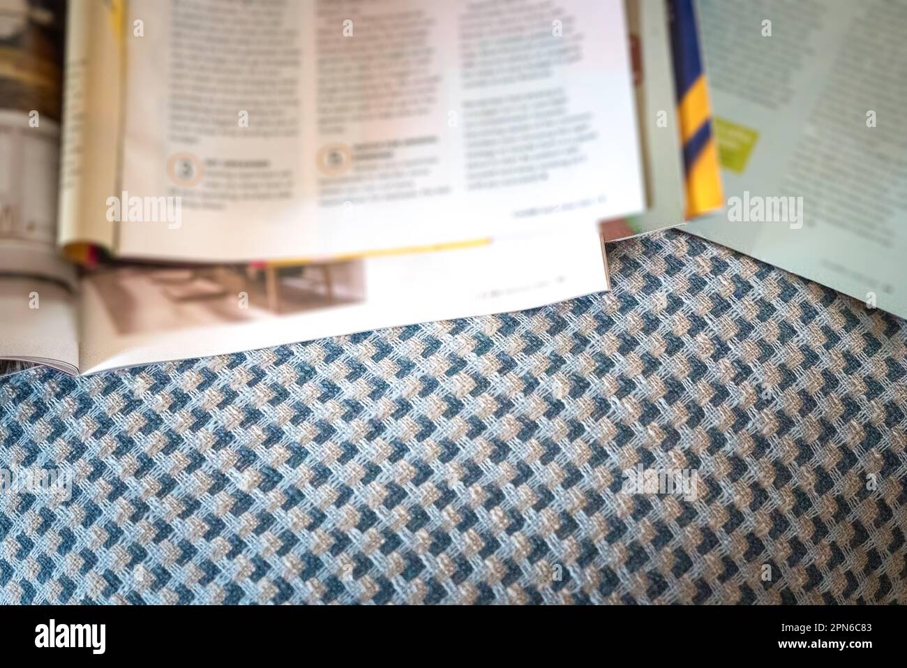Stack of magazines on top of couch. Top view, copy space Stock Photo ...