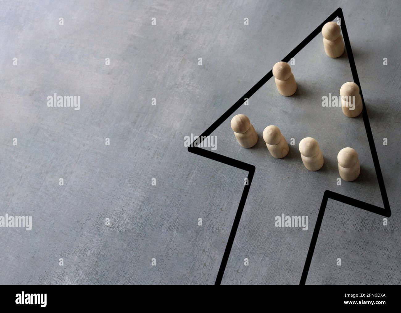 Group of wooden dolls and upward arrow with copy space. Leader ...