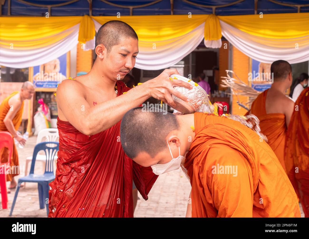 Ban Chang, Thailand - April 16, 2023: Monks pouring water with flower ...