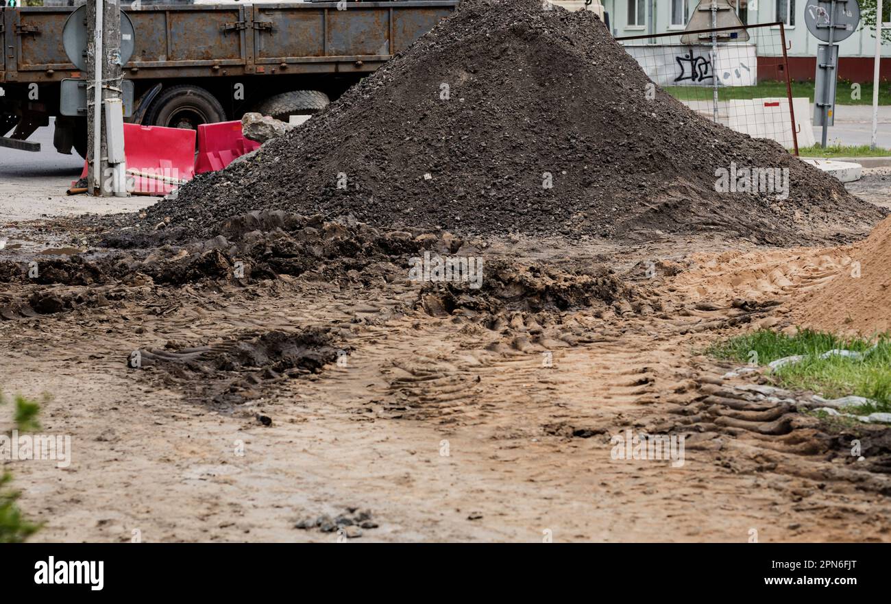 sand for construction work. a construction site with a pile of sand and ...