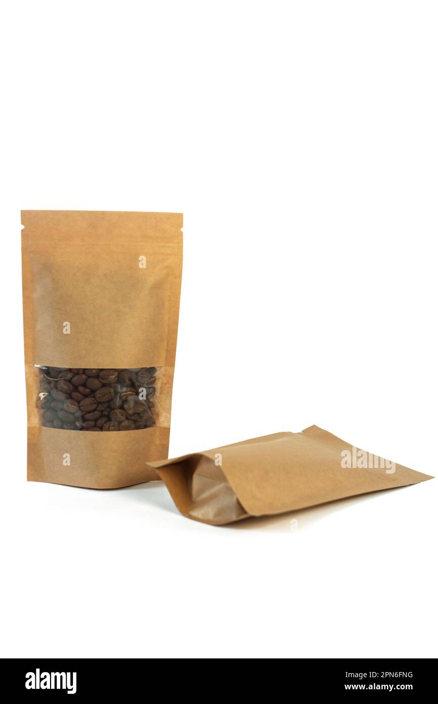 Brown kraft paper pouch bags with coffee beans front view on a wooden ...