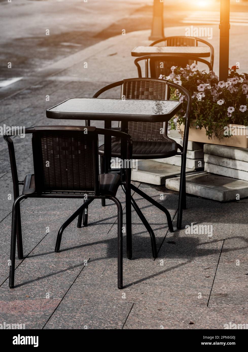 table and chairs at a sidewalk cafe. cozy street restaurant Stock Photo ...