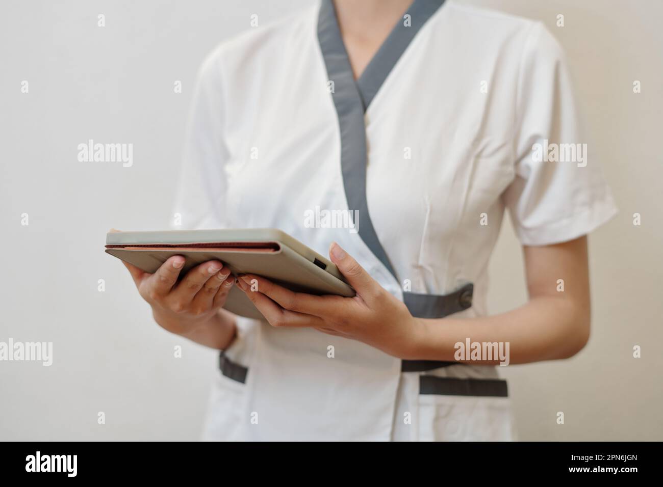 Spa salon receptionist checking schedule on tablet computer Stock Photo ...