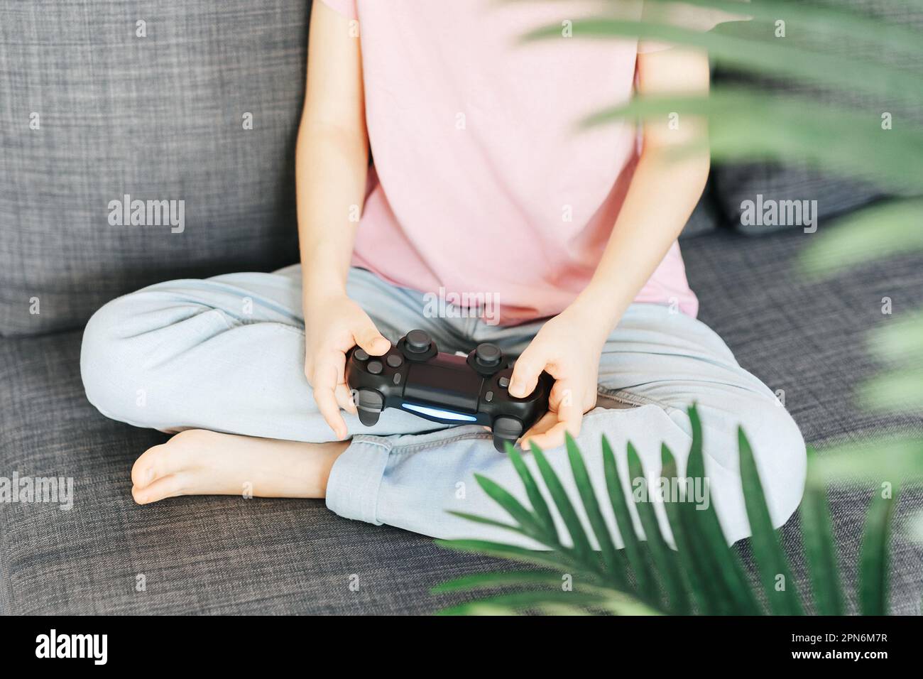 A little girl is playing with a game console at home Stock Photo - Alamy