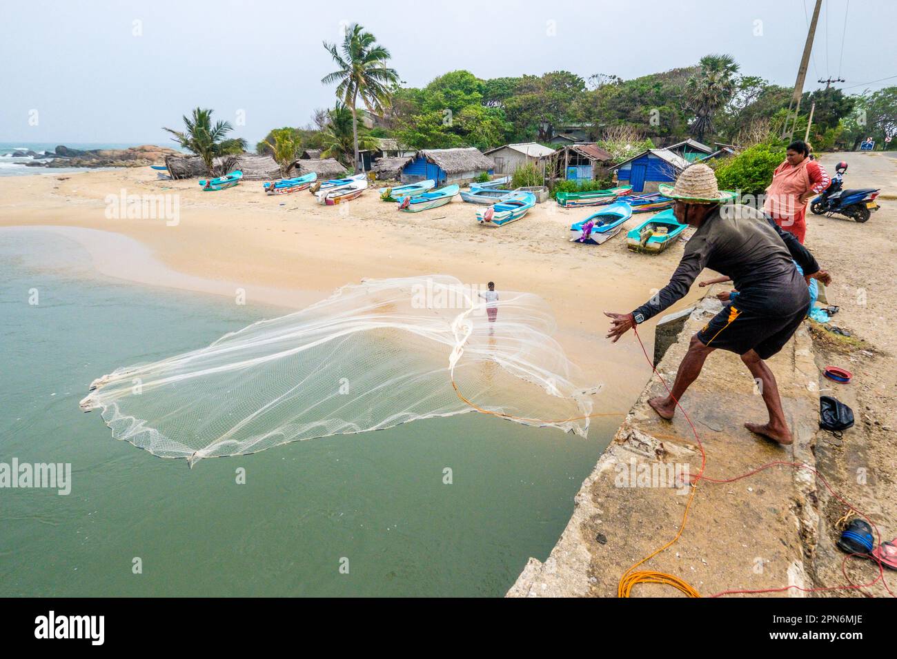 Fisherman casting a net from a bridge over a river in Sri Lanka Stock ...