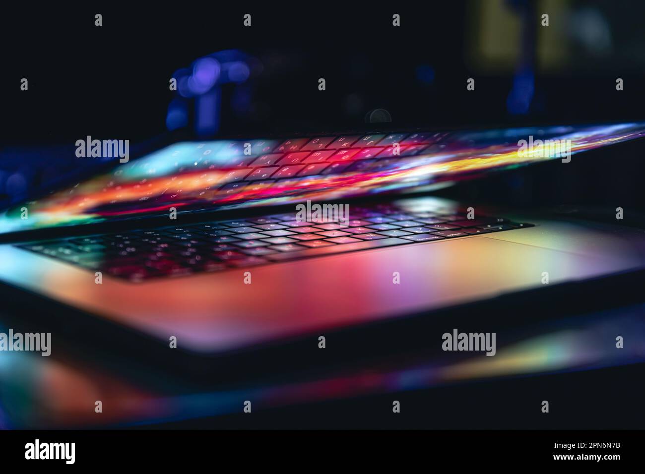 Close up of laptop keyboard colorful neon illumination, backlit ...