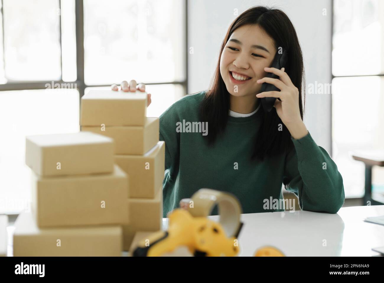 Female online business, store owner talking to customer using sm Stock ...