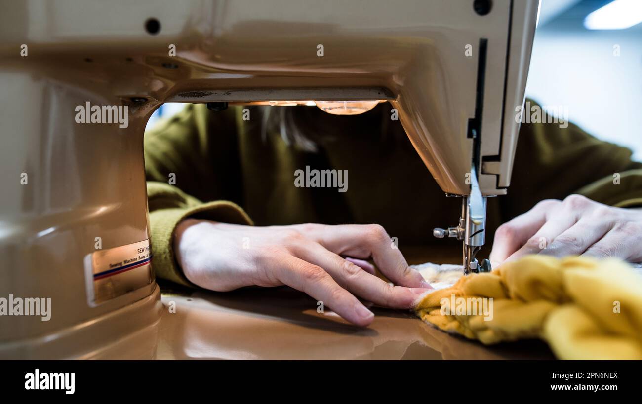Close up of woman's hands while using a sewing machine Stock Photo - Alamy