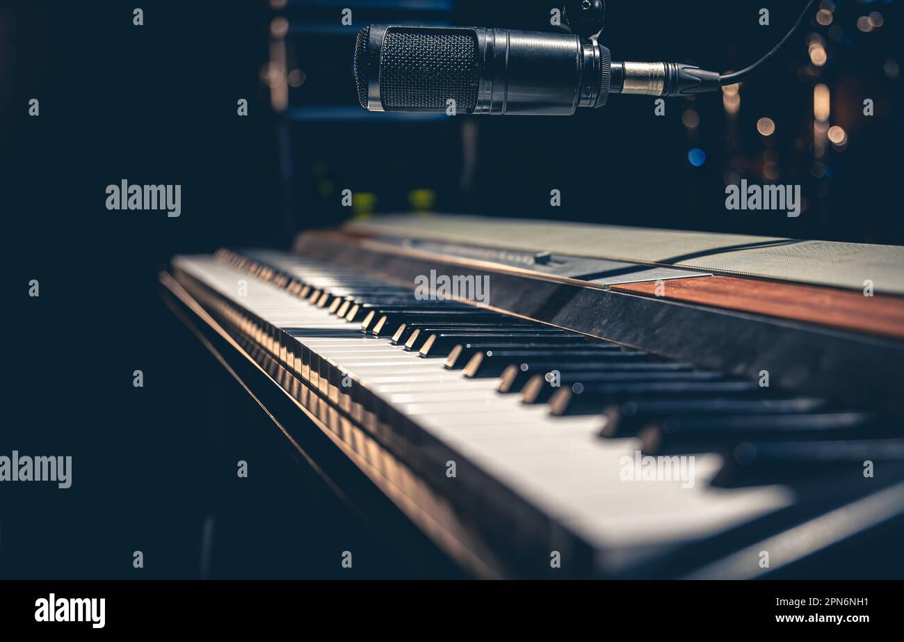 Music keys and a microphone on a dark background Stock Photo - Alamy